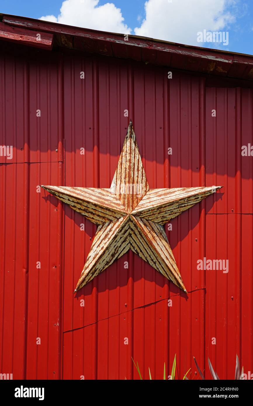 Traditional gold star on a red barn Stock Photo - Alamy