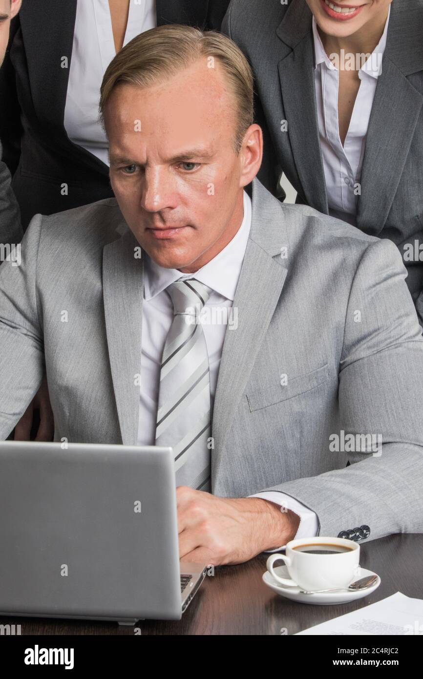 Team of business people working together using laptop unity cooperation ...