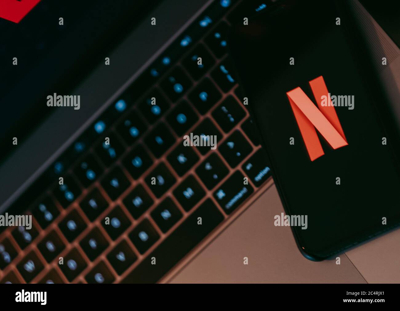 Smartphone and laptop with screen of Netflix logo Stock Photo - Alamy