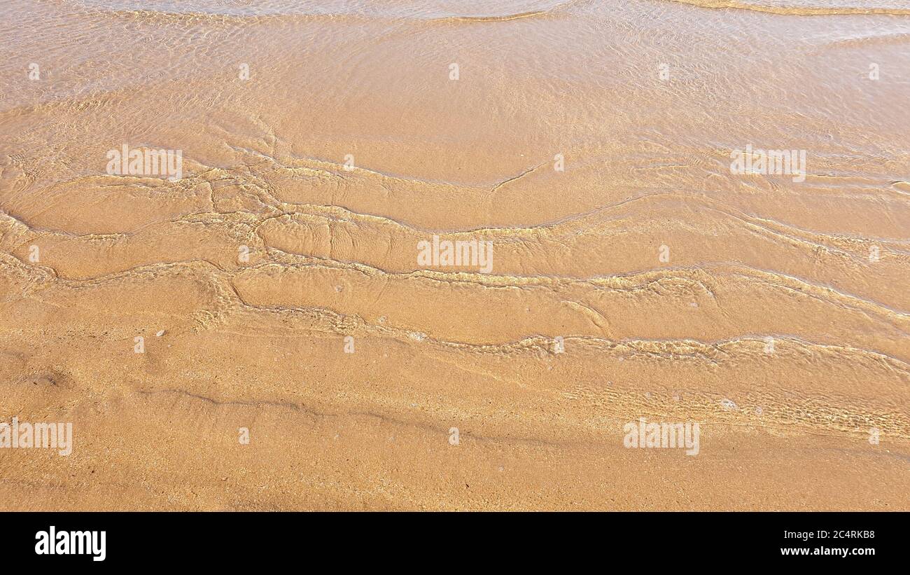 Sand patterns and sea Stock Photo - Alamy