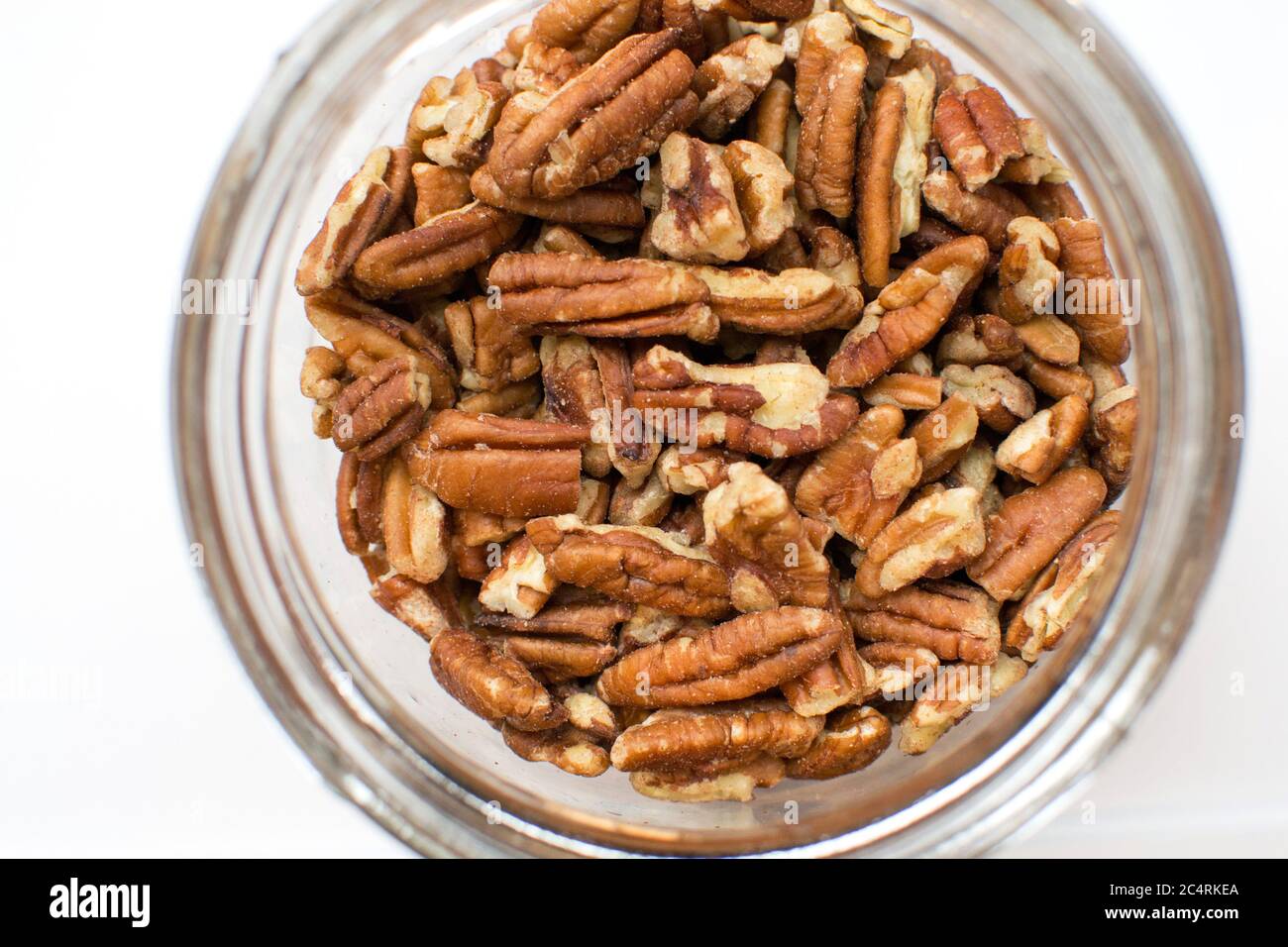Raw, whole pecans in a glass container Stock Photo - Alamy