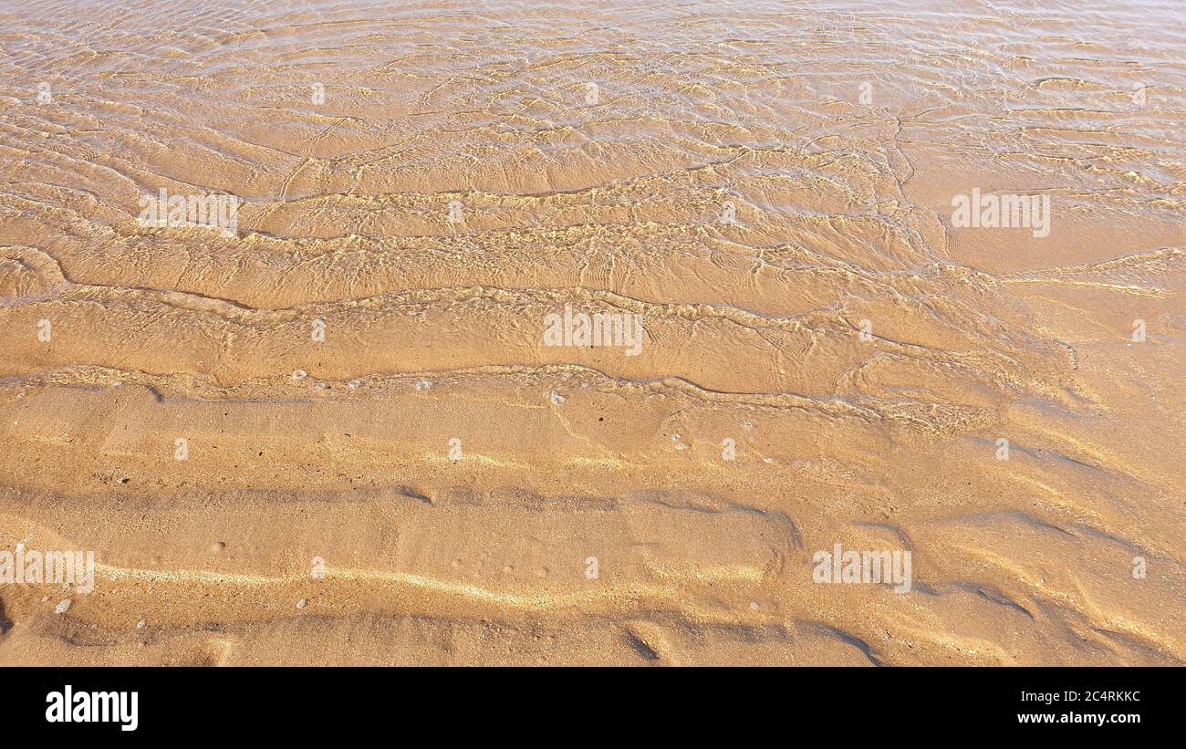 Sand patterns and sea Stock Photo - Alamy
