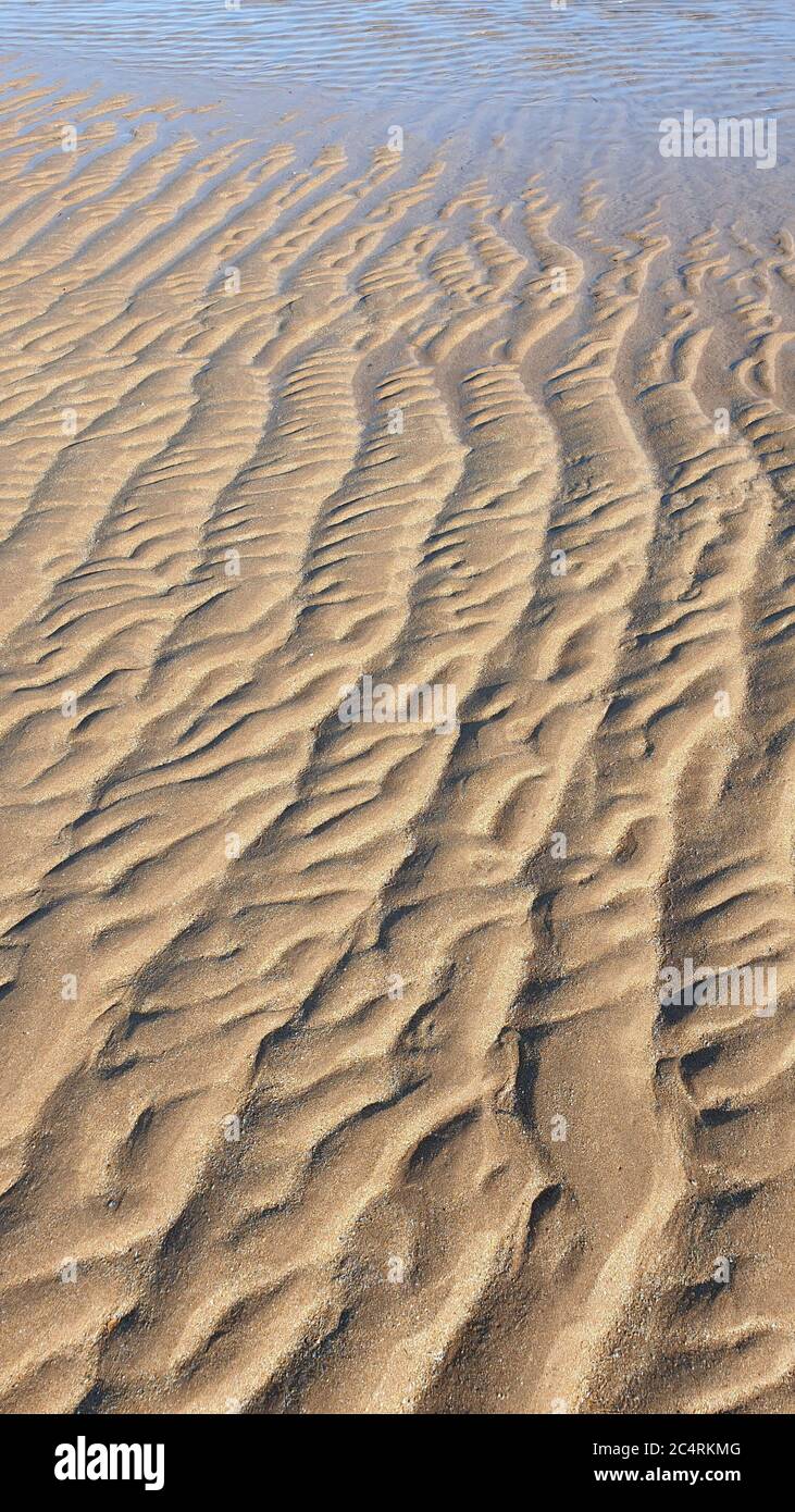 Sand patterns and sea Stock Photo - Alamy