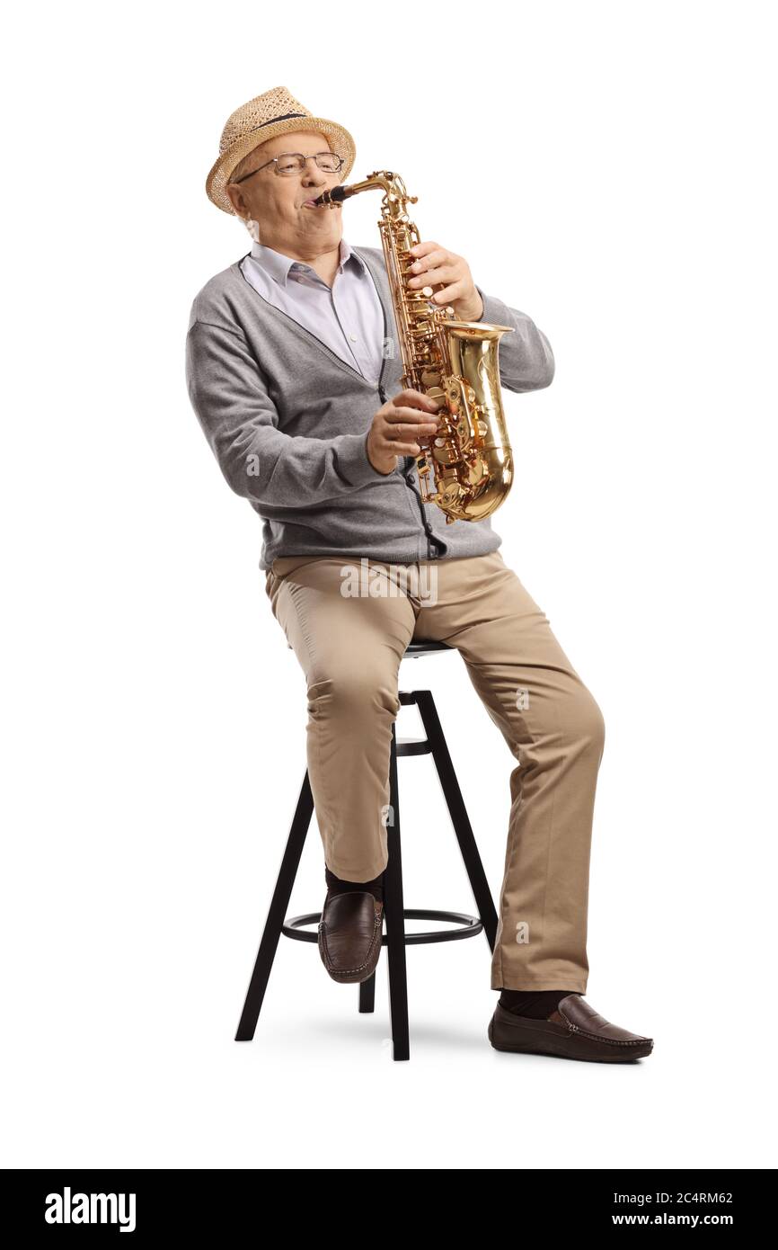 Elderly man musician playing a sax and sitting on a chair isolated on ...