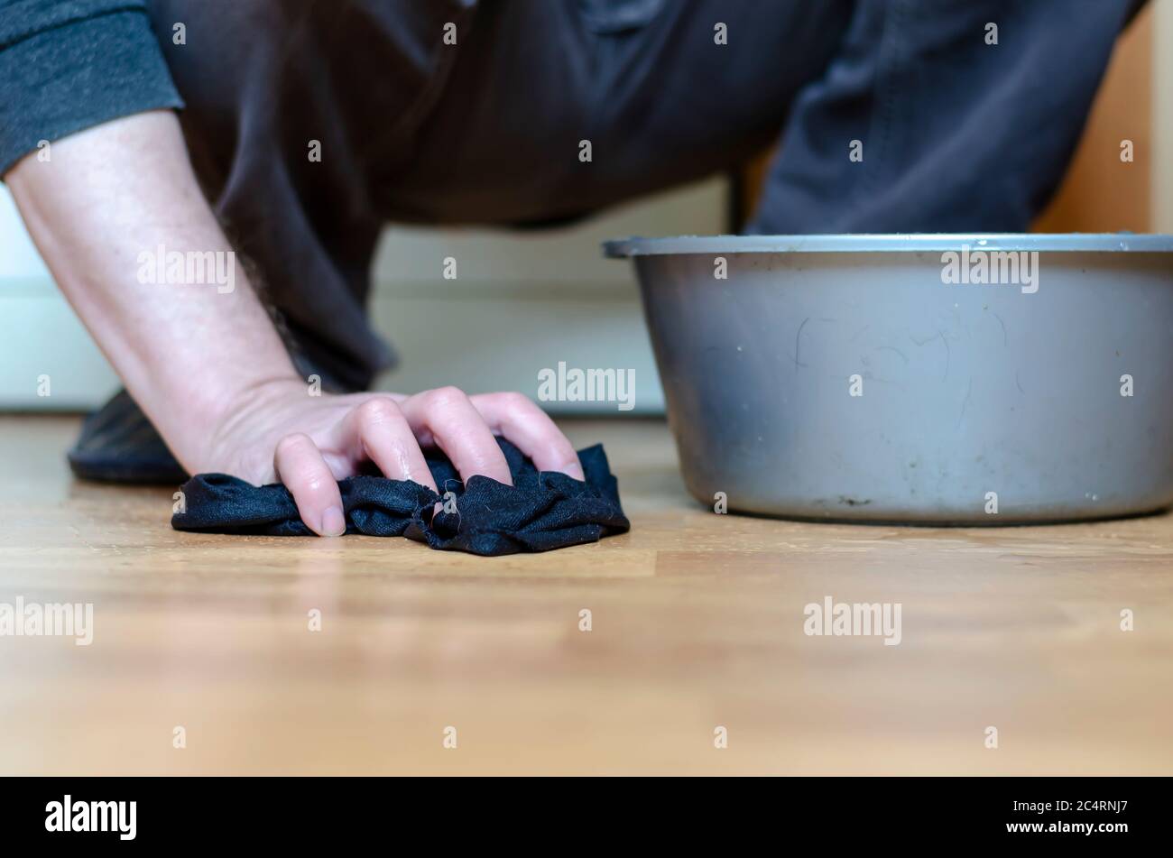 Man washes floors manually. The process of sanitary cleaning. Household ...