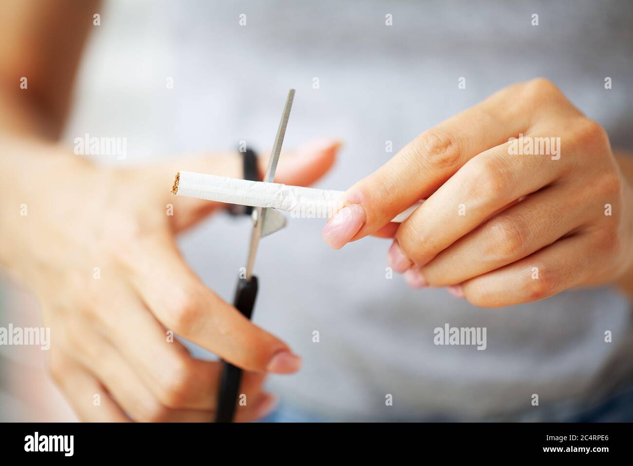 Stop smoking, close up of woman cuts a cigarette with scissors Stock ...
