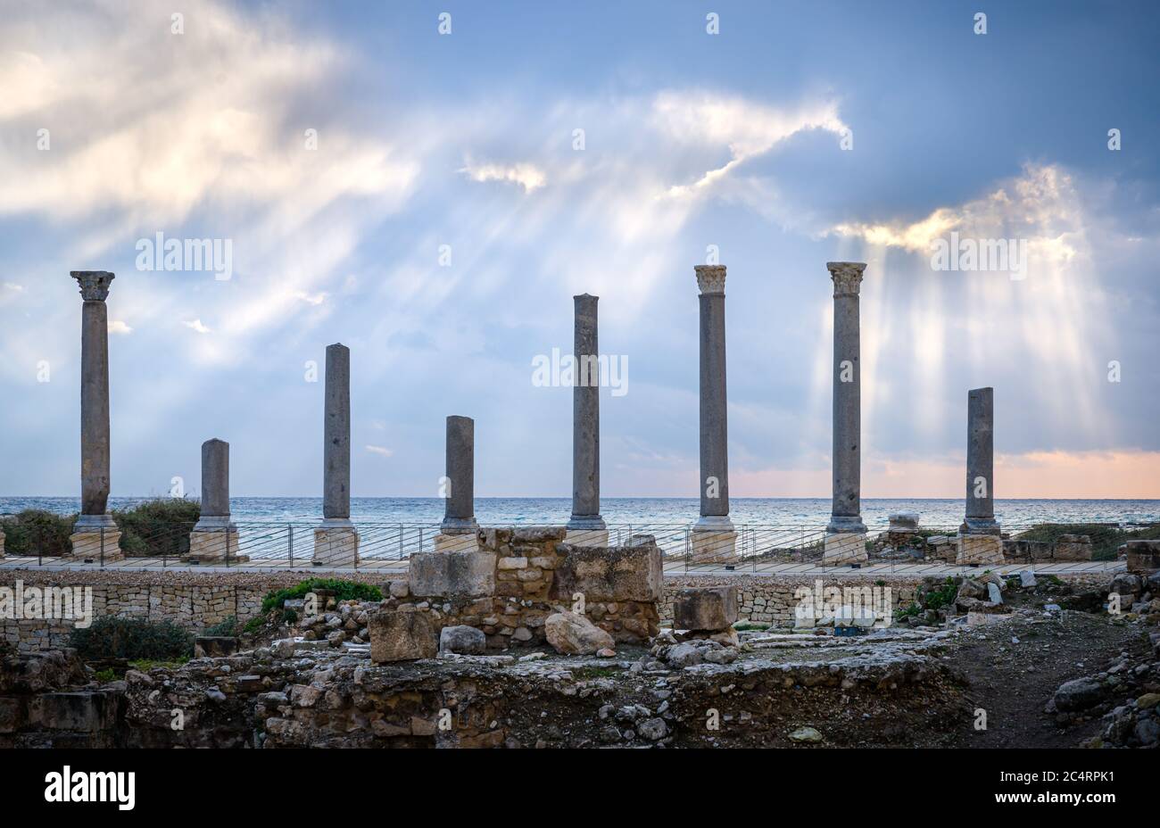 Aligned columns of a ruined ancient Roman temple in front of the ...