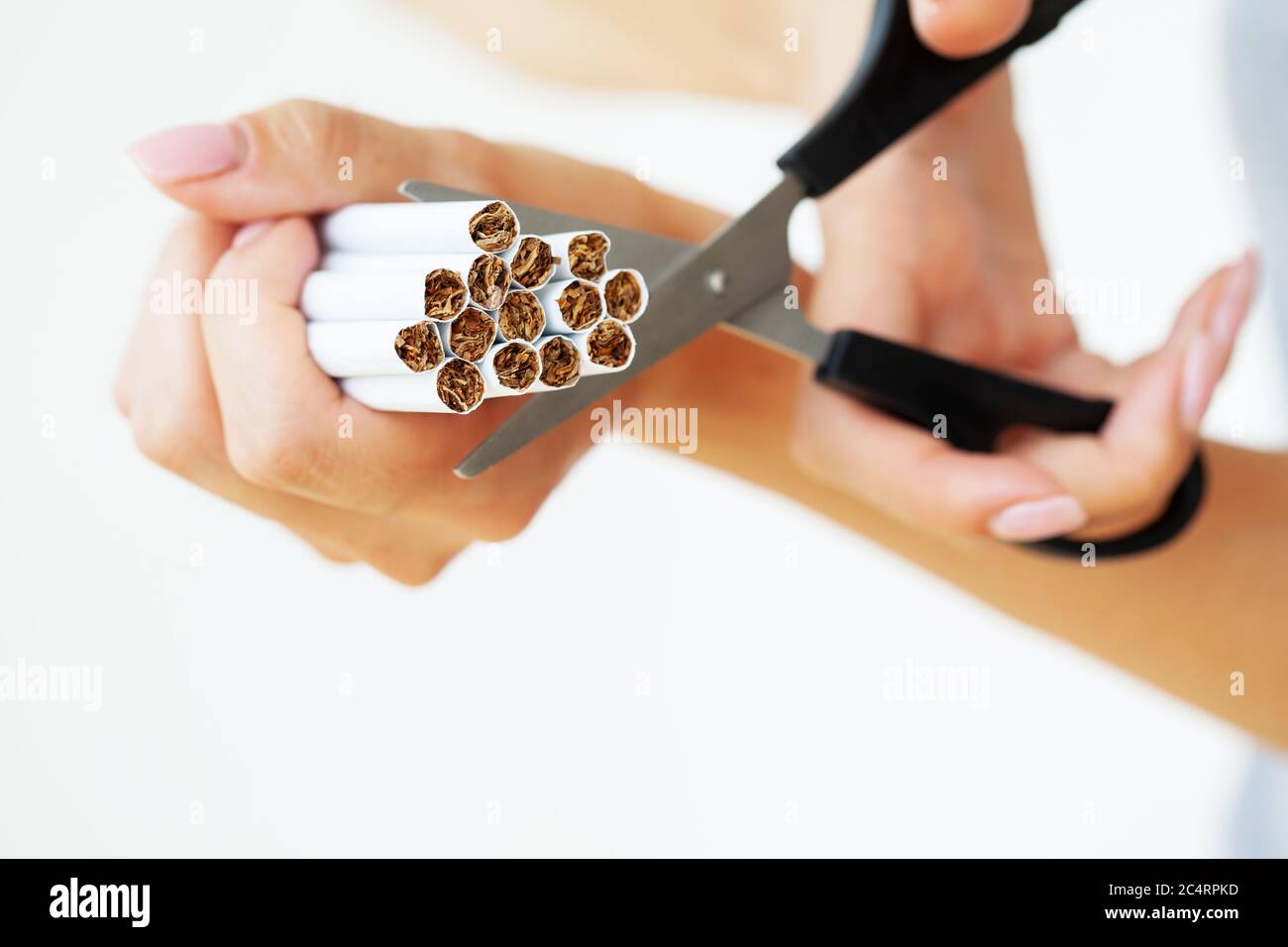Stop smoking, close up of woman cuts a cigarette with scissors Stock ...