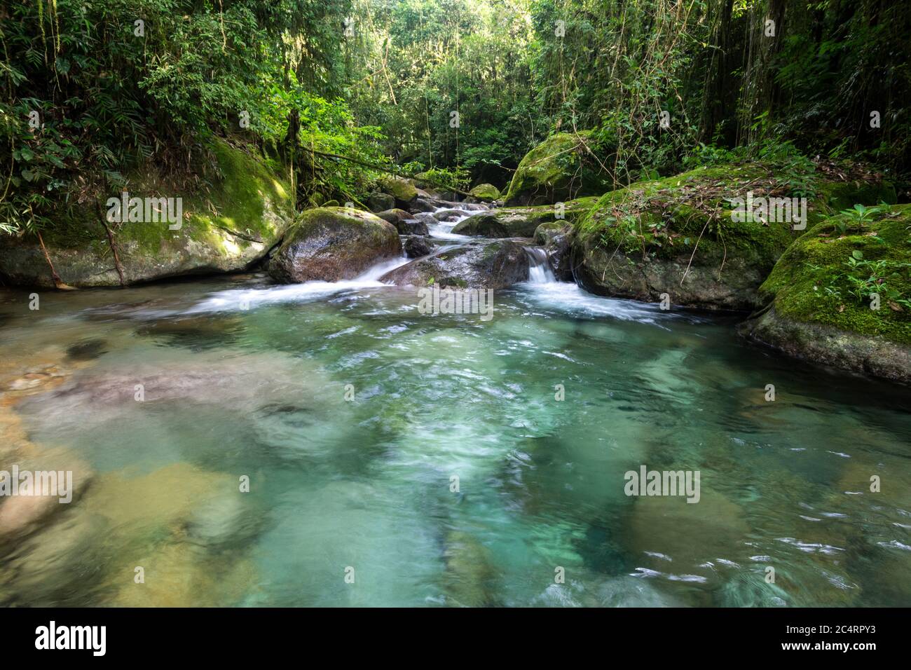 Beautiful crystal clear river with blue water on green rainforest ...
