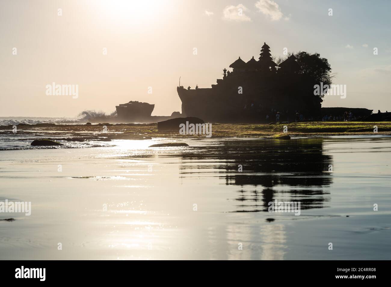 Backlit outline of Pura Tanah Lot Balinese sea temple with crashing ...