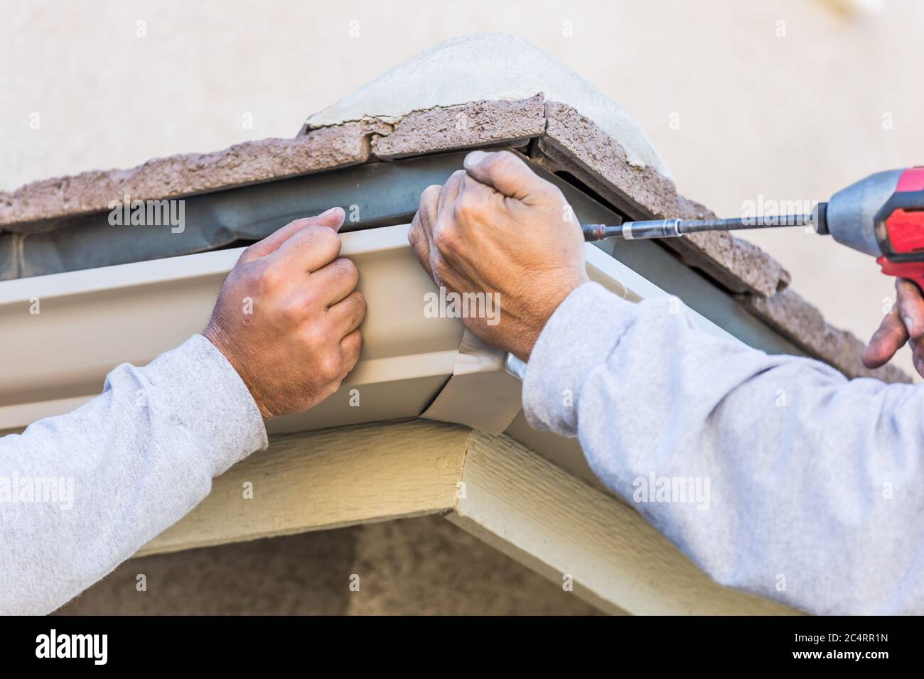 Workers Attaching Aluminum Rain Gutter to Fascia of House Stock Photo ...