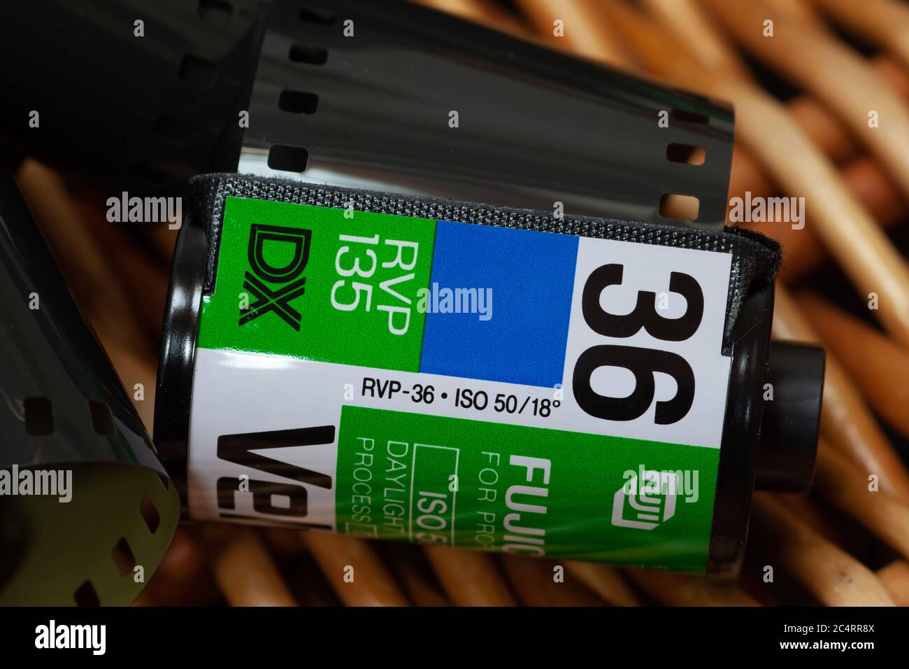 Roll of 35mm Fujichrome Velvia colour transparency film on wicker ...