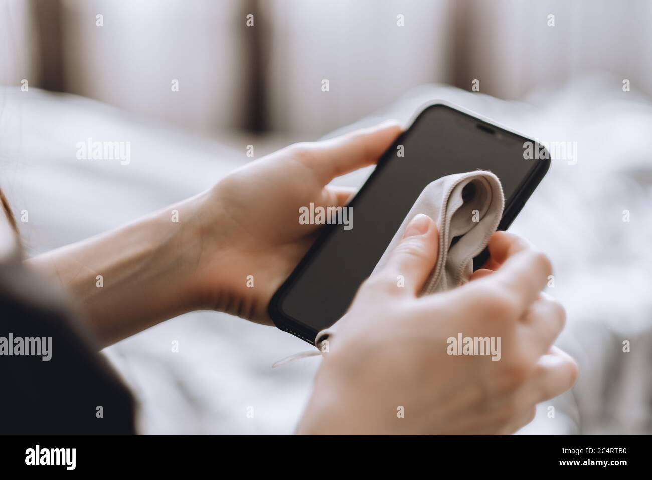 Cleaning the smartphone screen with a fiber cloth Stock Photo - Alamy
