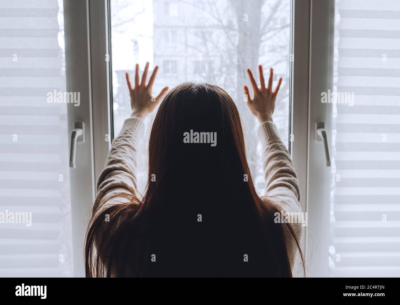 Female touches hands to the window glass Stock Photo - Alamy