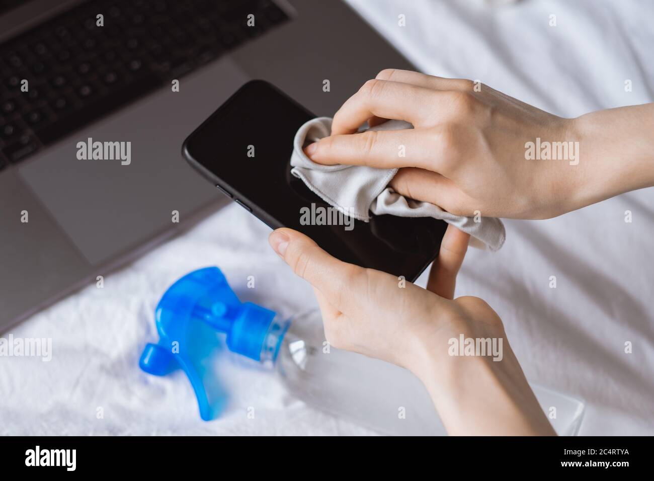 Cleaning the smartphone screen with a fiber cloth Stock Photo - Alamy