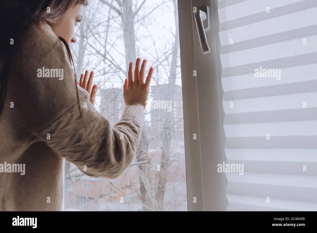 Female touches hands to the window glass Stock Photo - Alamy