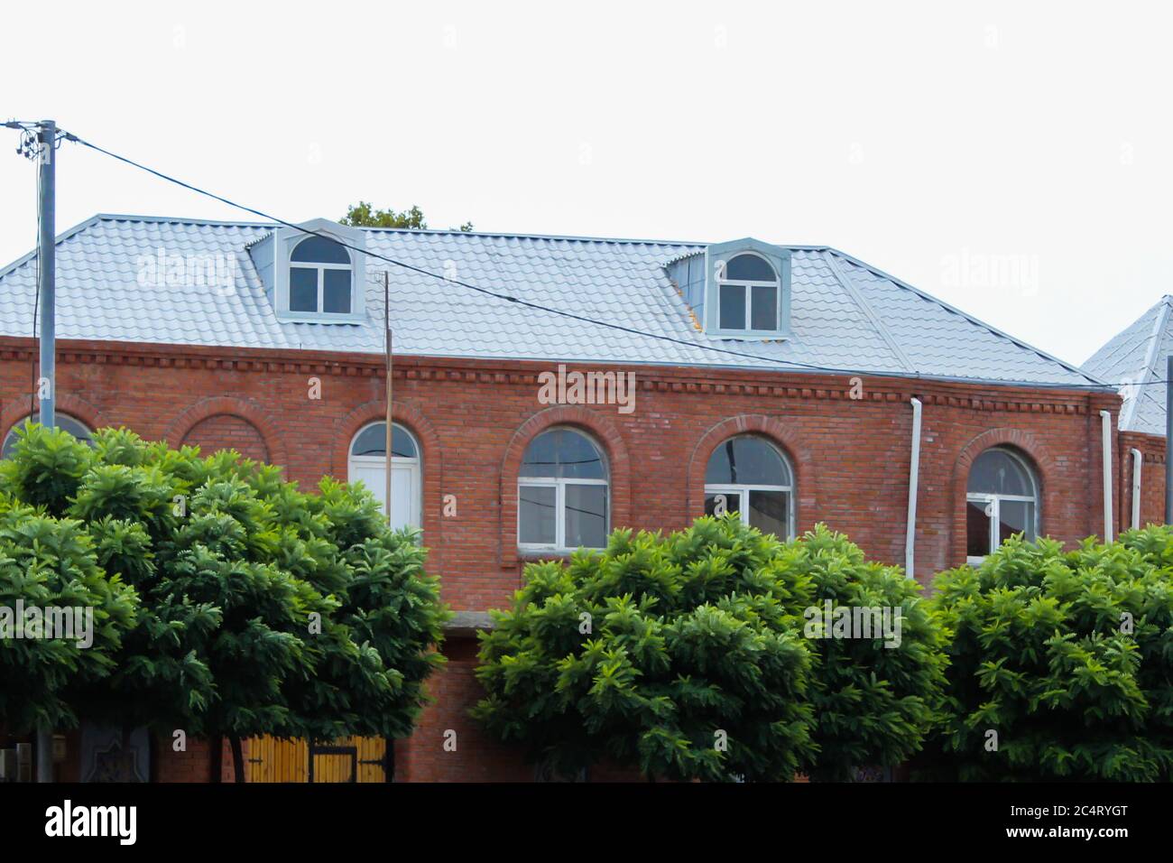 Red brick house and a city planted with green trees and interesting ...
