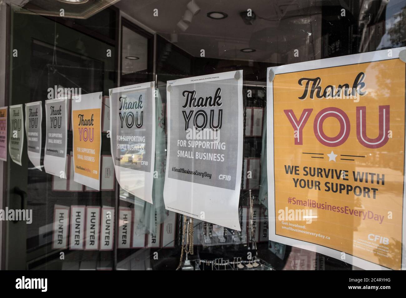 Posters pasted in the window of a local store Stock Photo - Alamy
