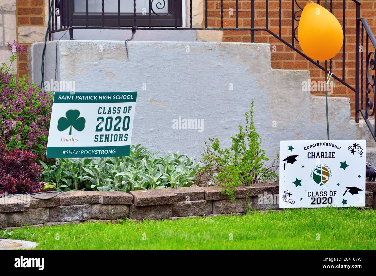 Chicago, Illinois, USA. A pair of signs and a balloon honor a high ...