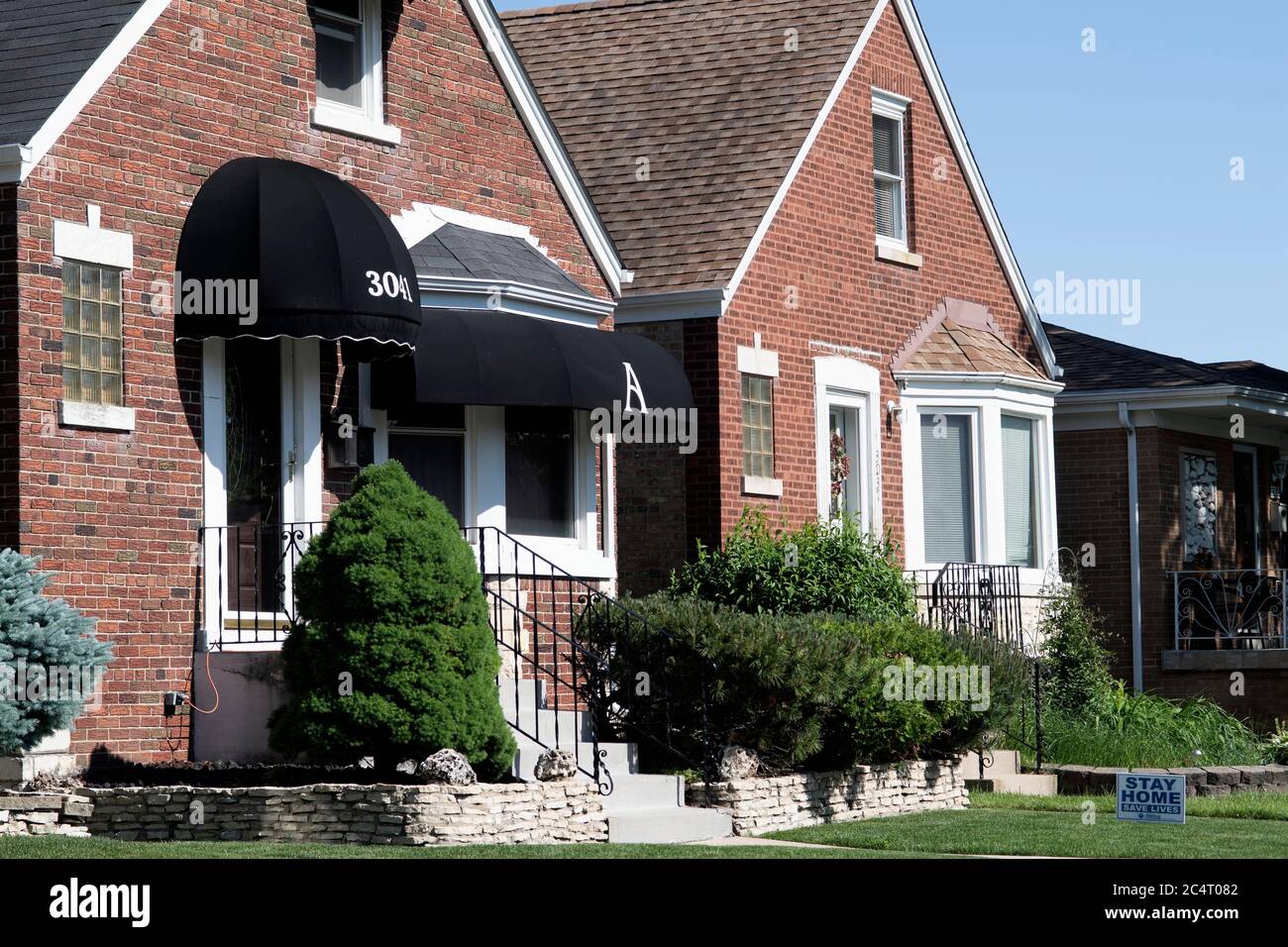 Chicago, Illinois, USA. A pair of brick homes on a quiet block located ...