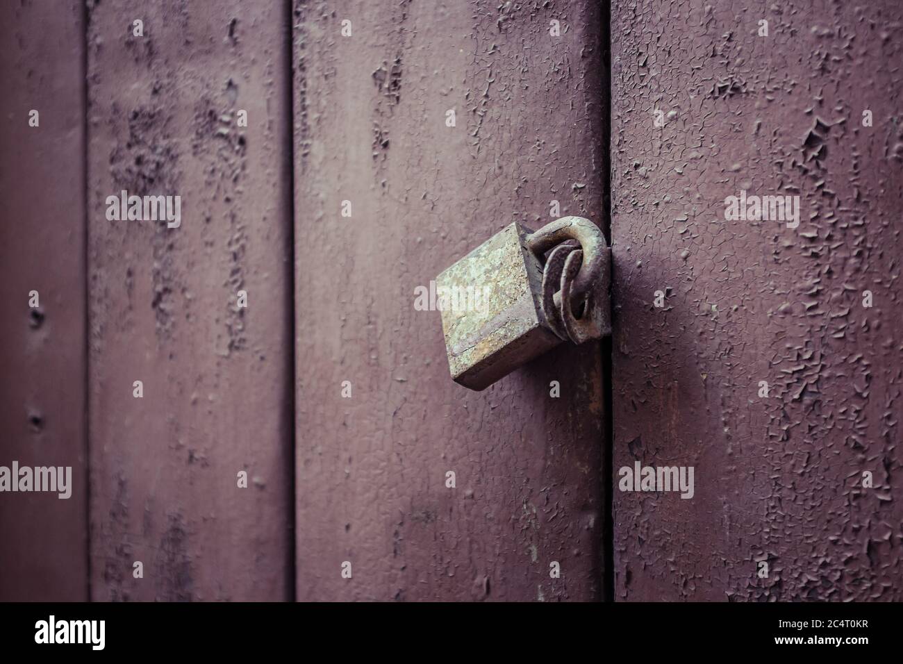 Lock attached to the doors of dark violet color Stock Photo - Alamy