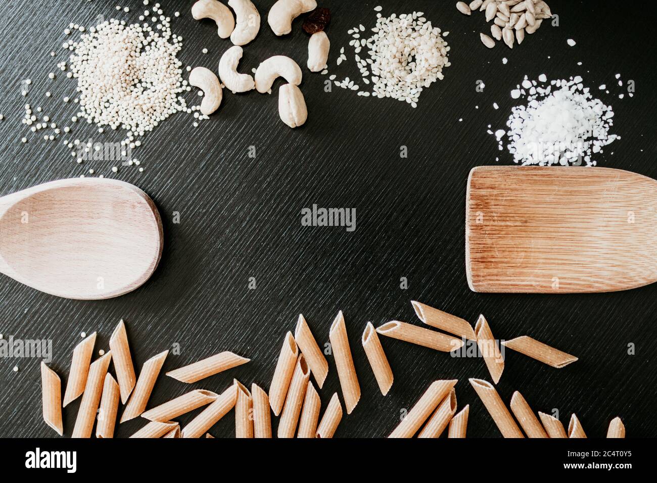 Various seeds with peanuts, red beans and penne pastas scattered on the ...