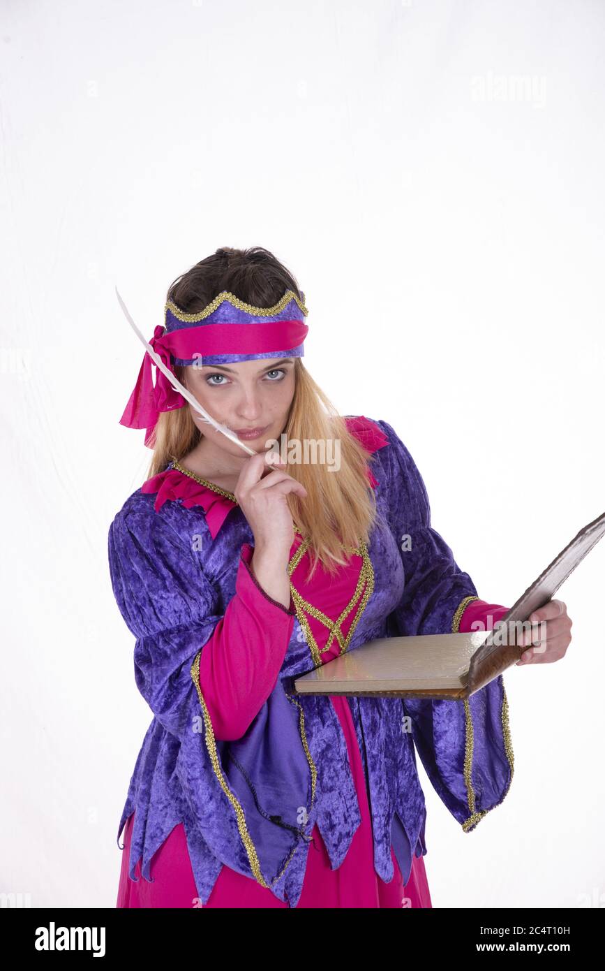 Female in a pink and purple medieval costume posing with a book and a ...