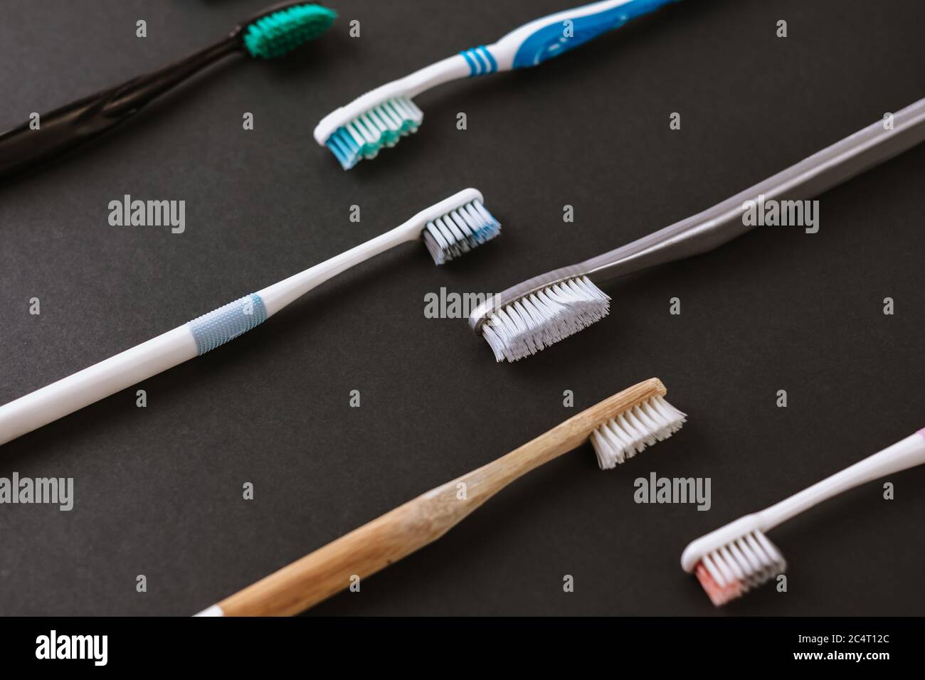 Different types of toothbrushes on a black background Stock Photo - Alamy