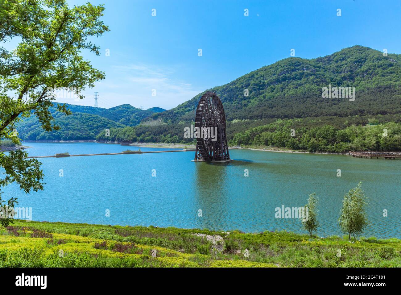 Large wooden waterwheel and blue water, Xijiao National Forest Park ...