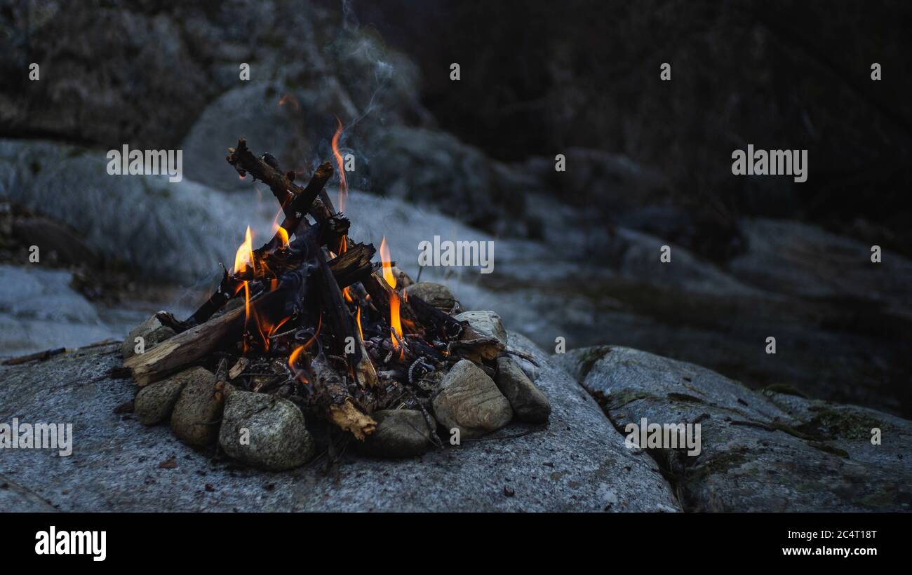 Small bonfire with beautiful flames on the rocks Stock Photo - Alamy