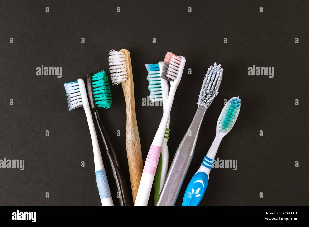 Different types of toothbrushes on a black background Stock Photo - Alamy
