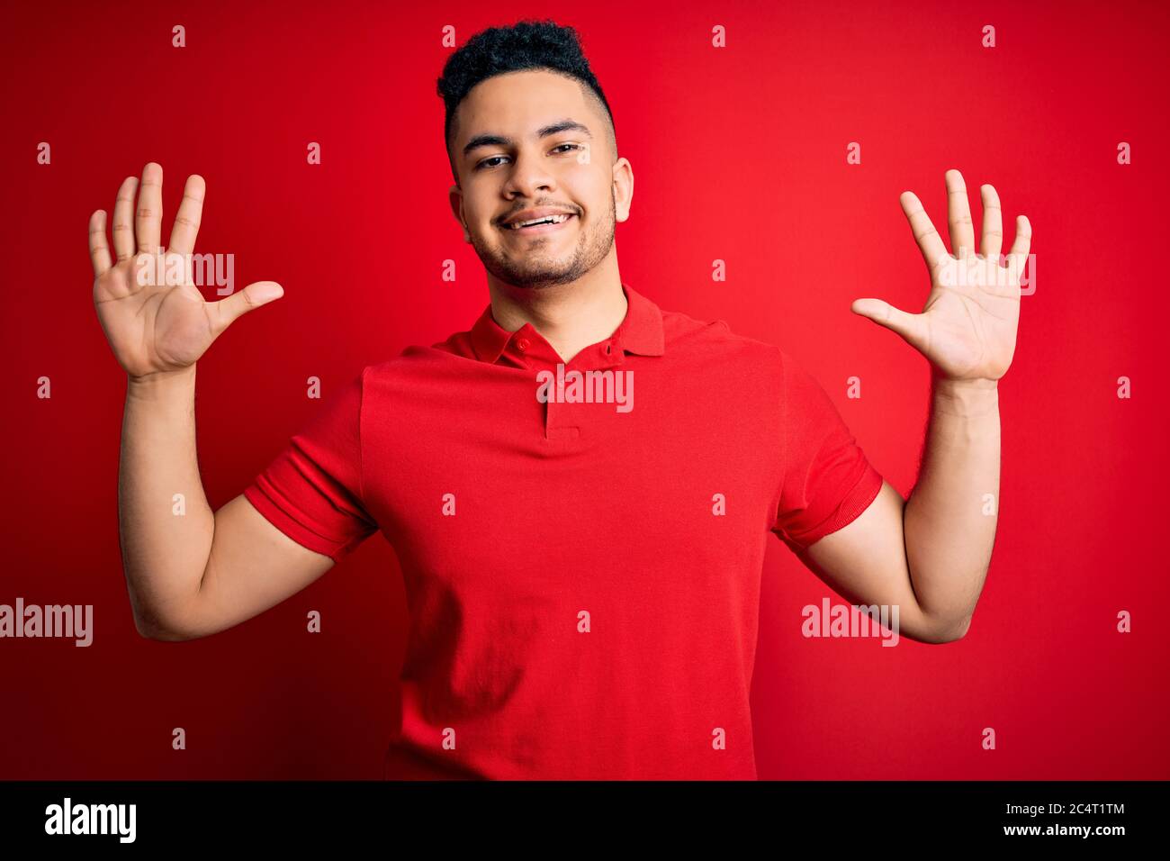 Young handsome man wearing red casual polo standing over isolated ...