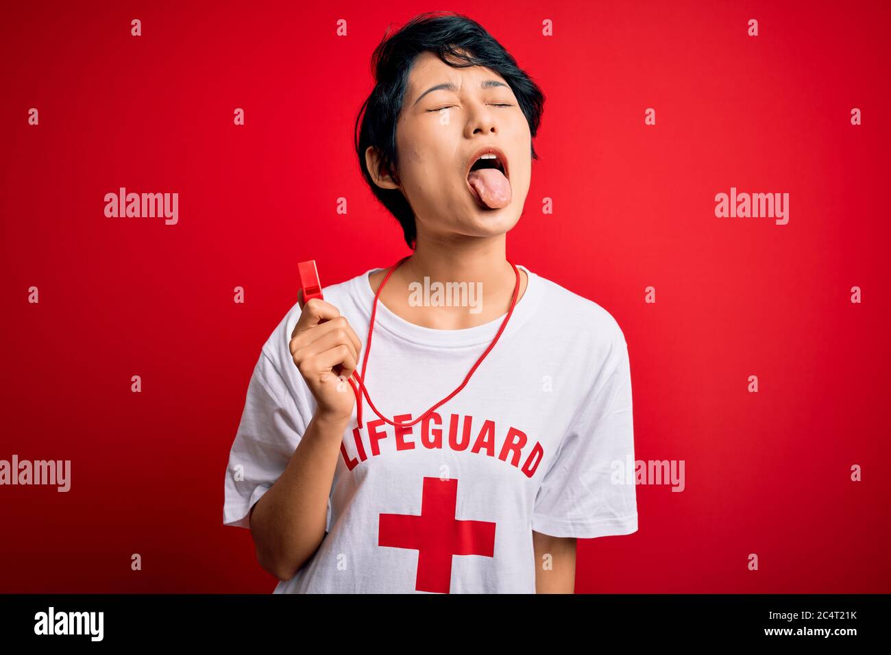 Young beautiful asian lifeguard girl wearing t-shirt with red cross ...