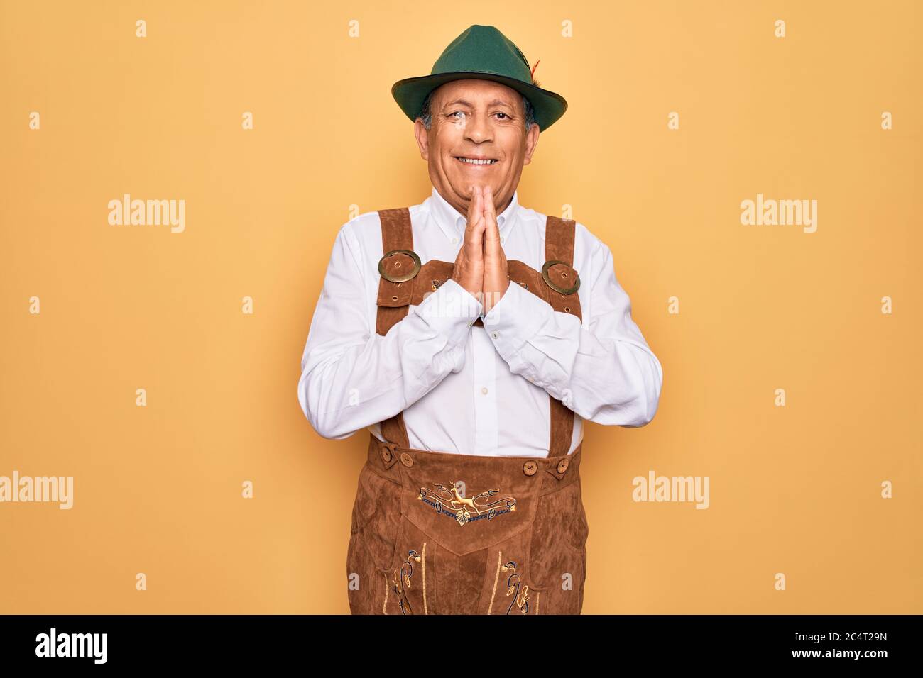 Senior grey-haired man wearing german traditional octoberfest suit over ...