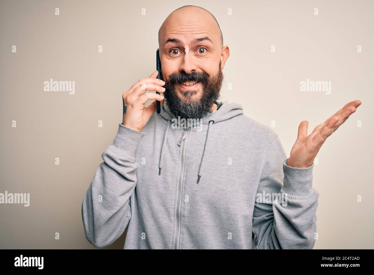 Handsome bald man with beard having conversation talking on the ...