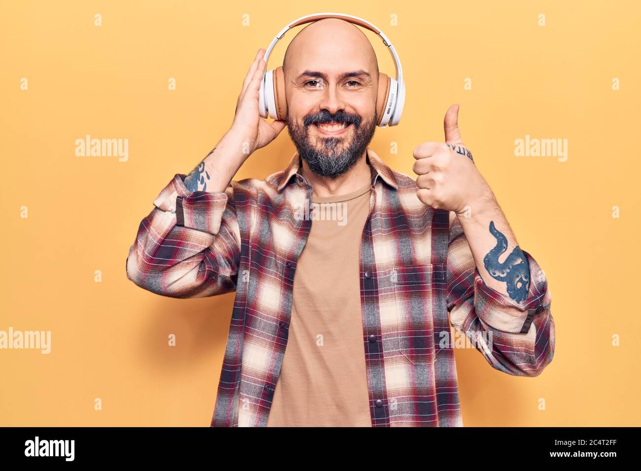 Young handsome man listening to music using headphones smiling happy ...