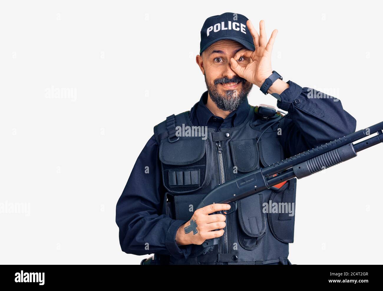 Young handsome man wearing police uniform holding shotgun smiling happy ...