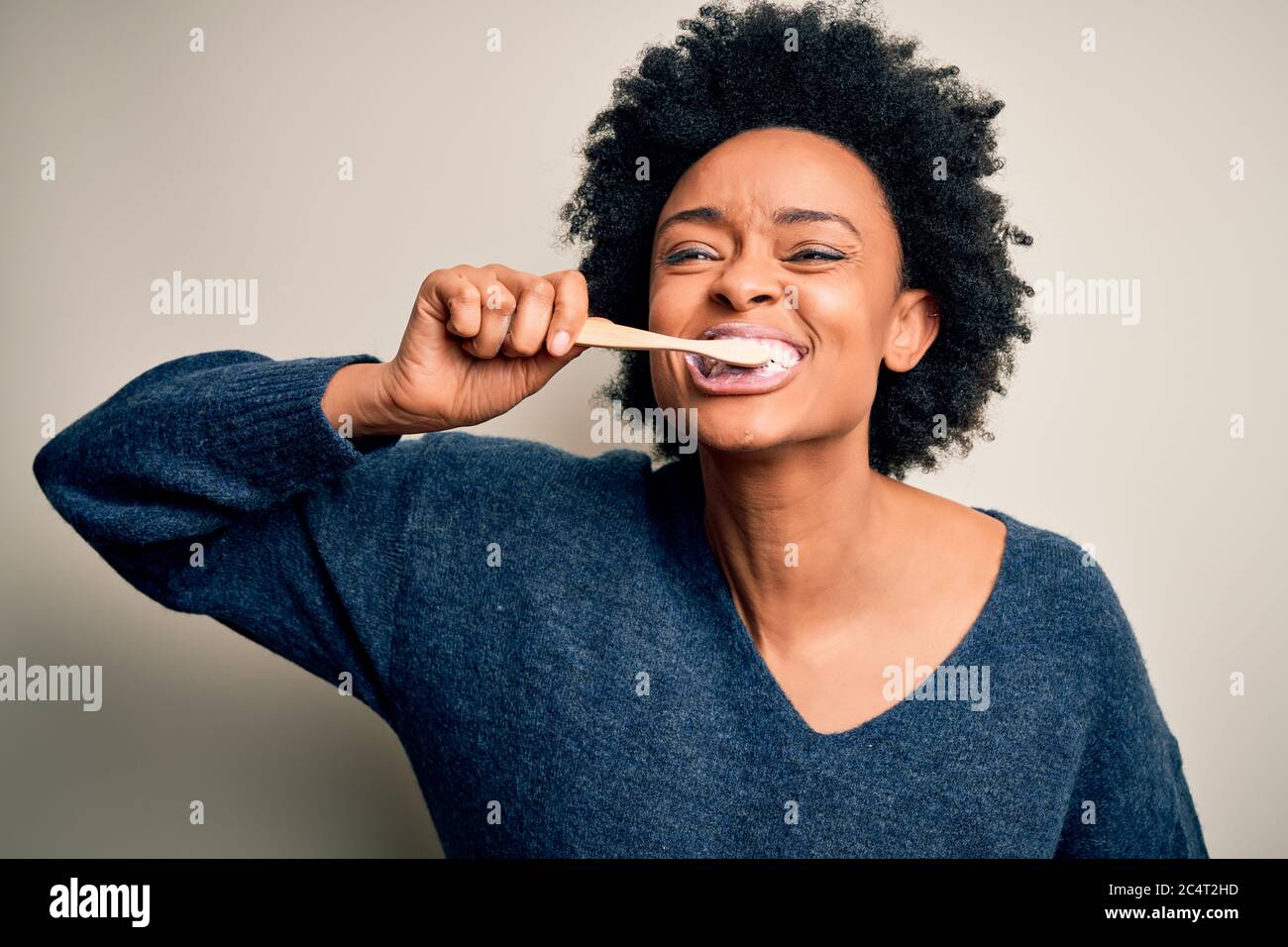African american woman brushing her teeth using tooth brush and oral ...