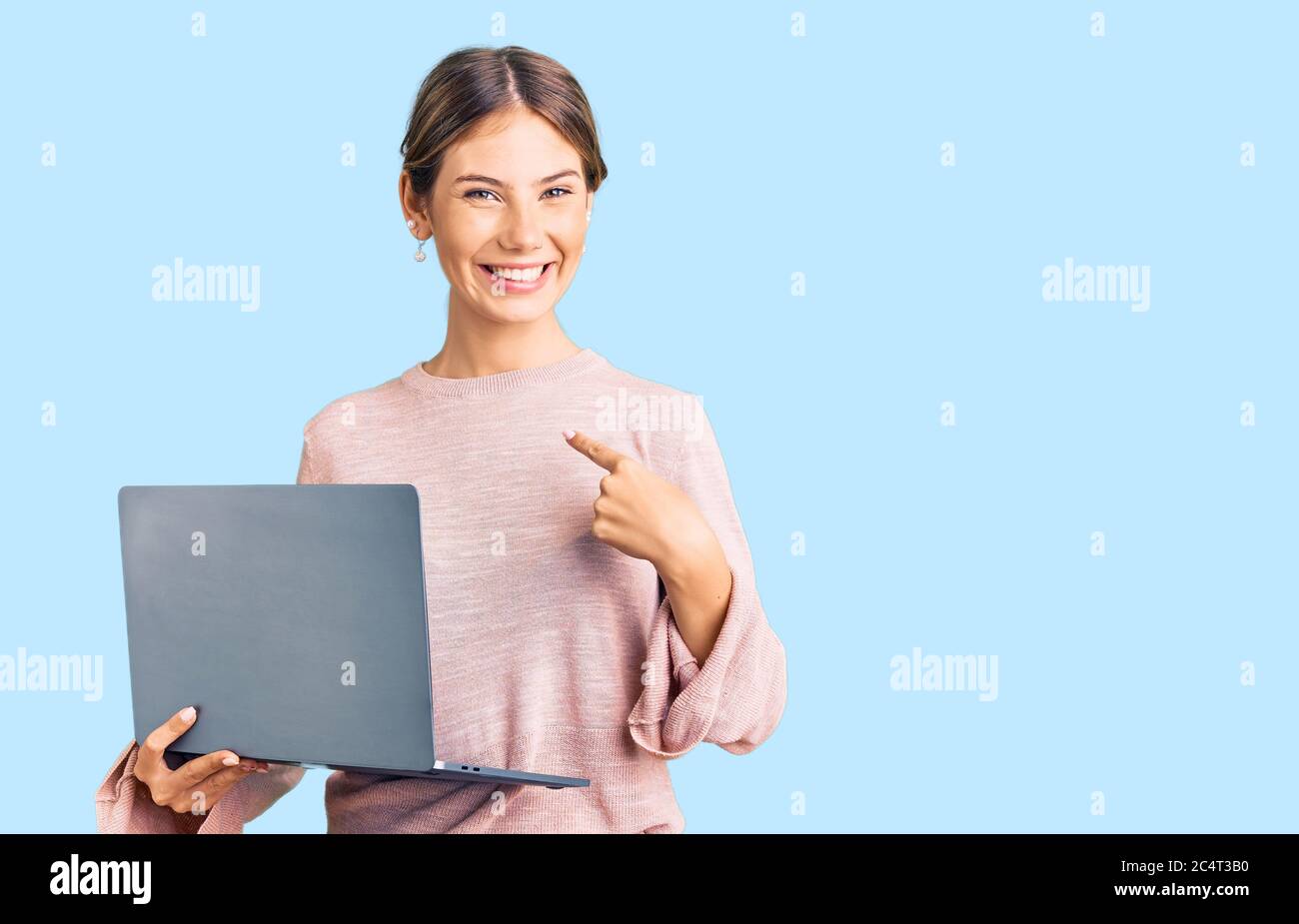 Beautiful caucasian woman with blonde hair working using computer ...