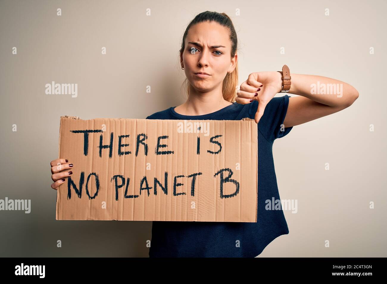 Young beautiful blonde woman with blue eyes asking for protect planet ...