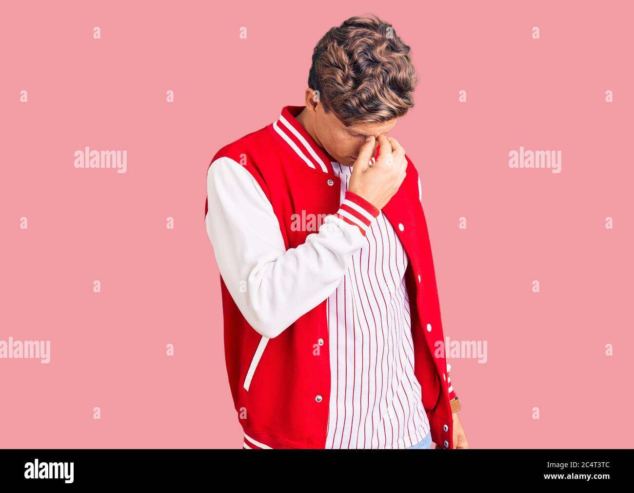 Young handsome man wearing baseball uniform tired rubbing nose and eyes ...