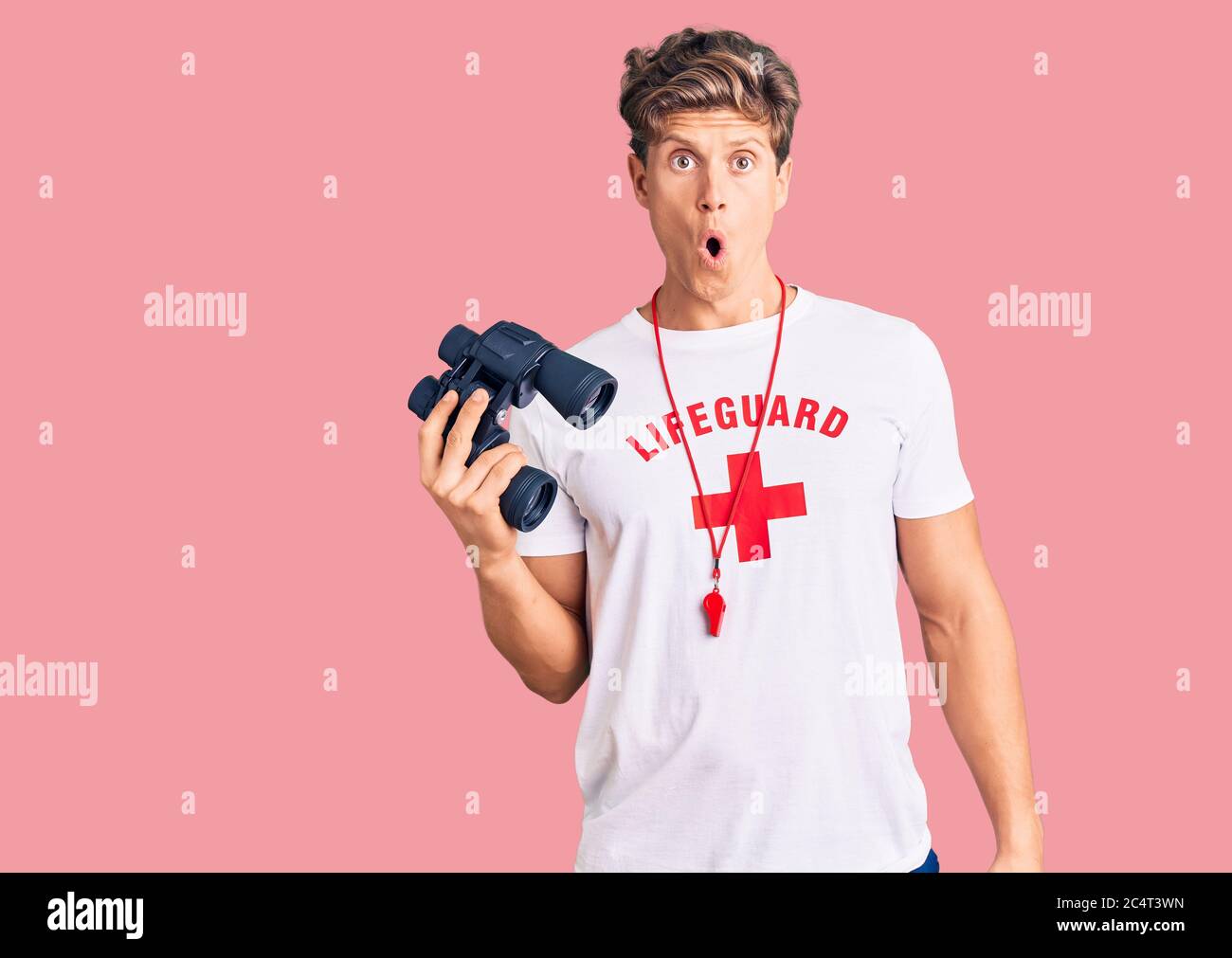 Young handsome man wearing lifeguard t-shirt using binoculars scared ...