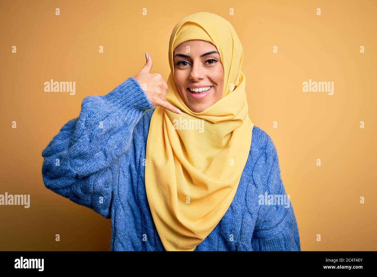 Young beautiful brunette muslim woman wearing arab hijab over isolated ...