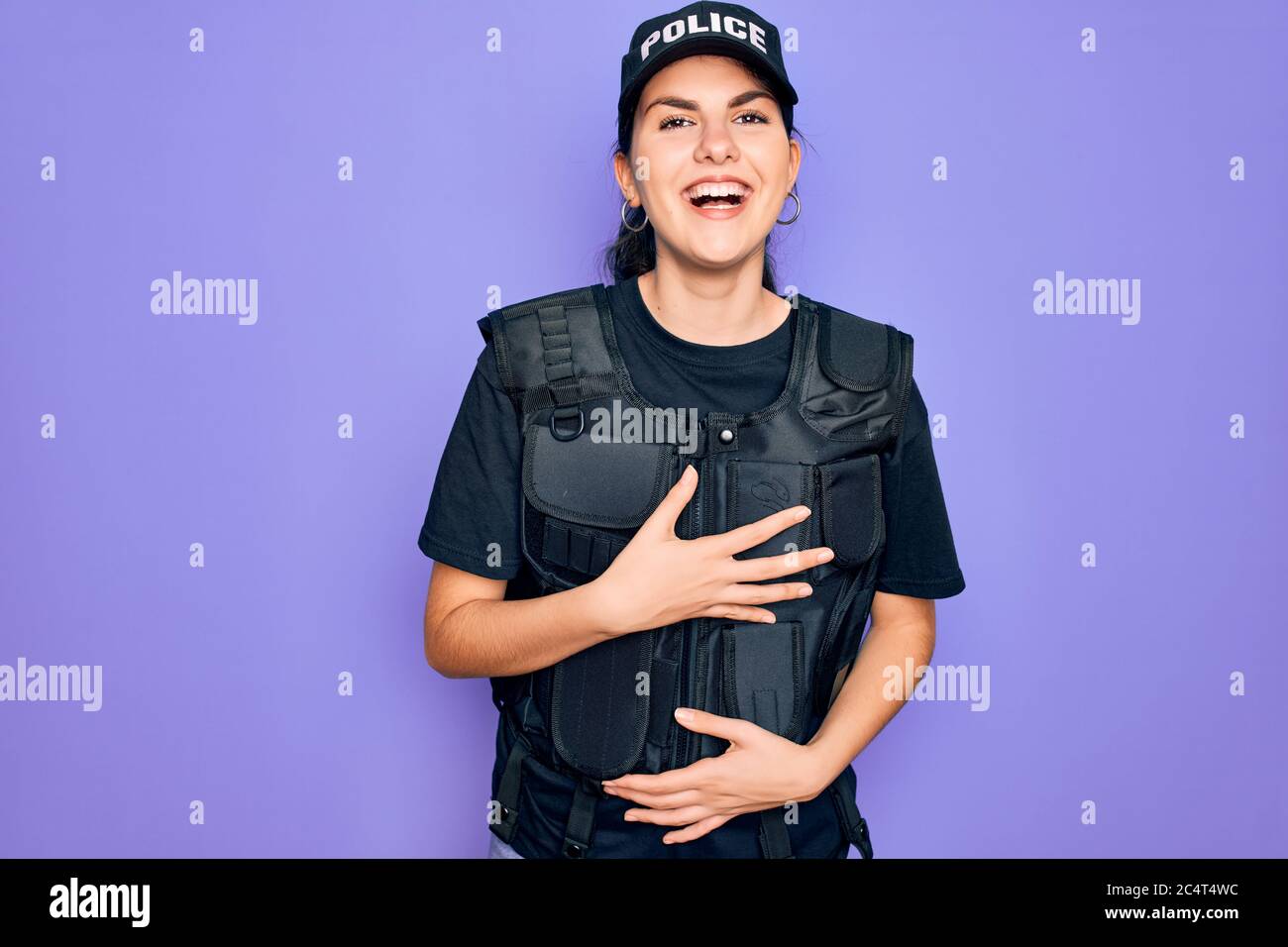 Young police woman wearing security bulletproof vest uniform over ...