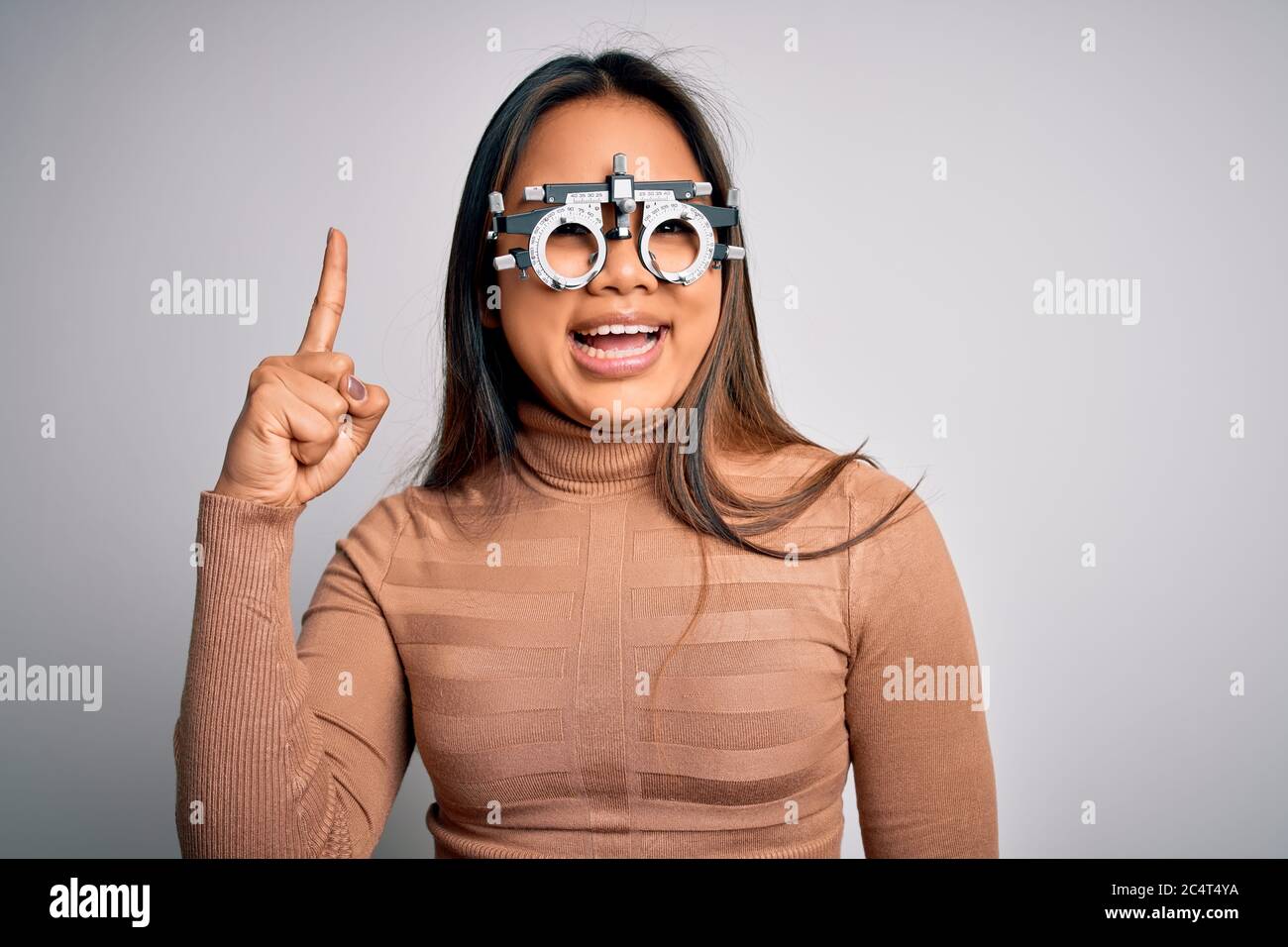 Young asian optical girl controlling eyesight using optometry glasses ...