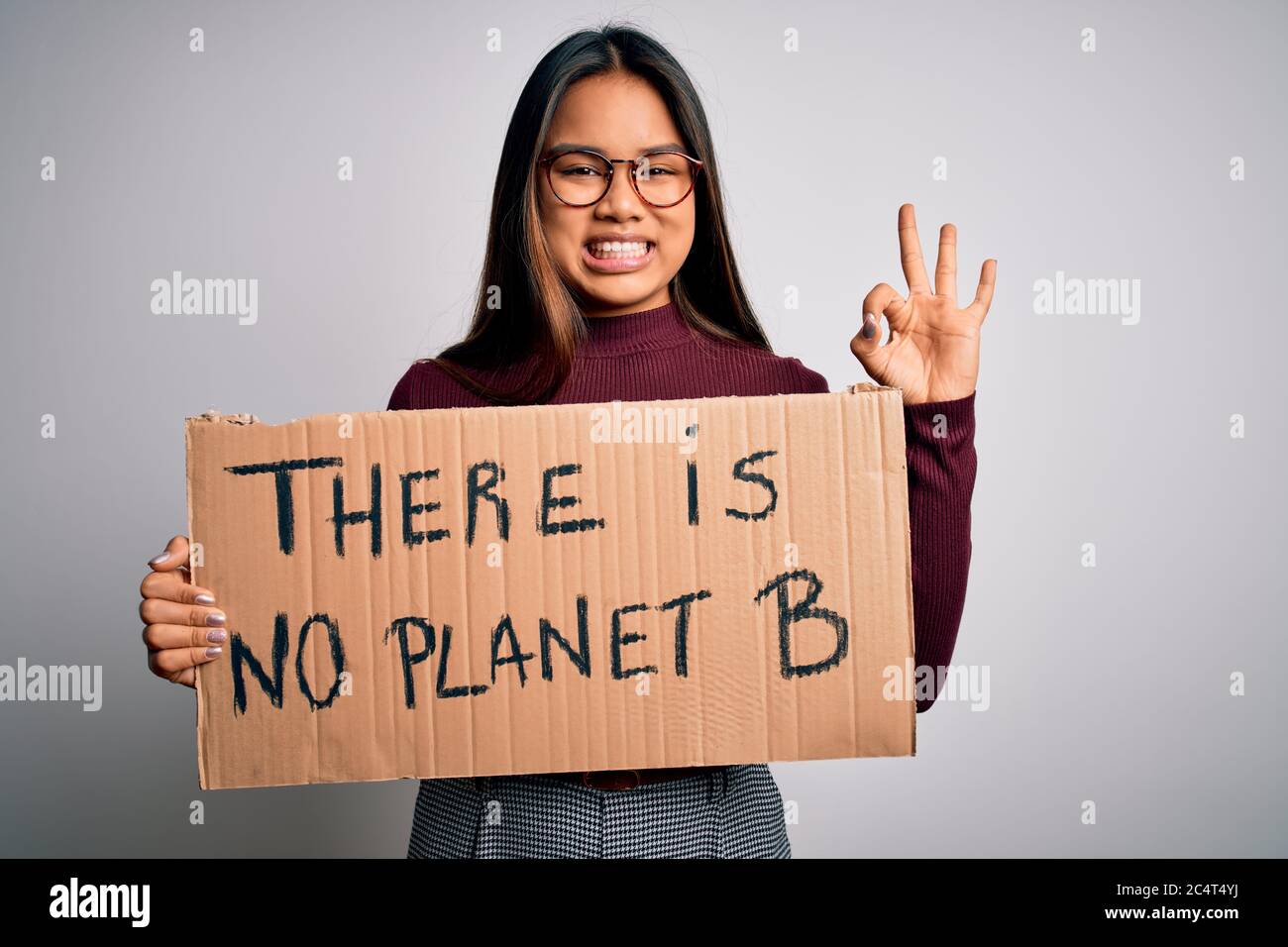 Young asian activist girl asking for environment holding banner with ...
