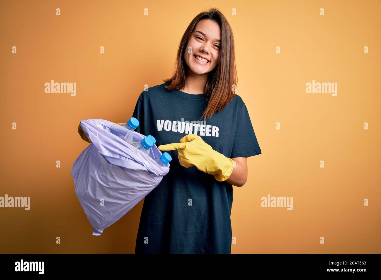 Beautiful volunteer girl caring environment doing volunteering holding ...