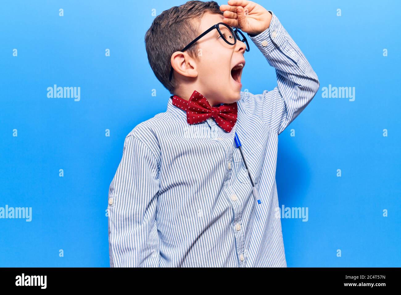Cute blond kid wearing nerd bow tie and glasses very happy and smiling ...