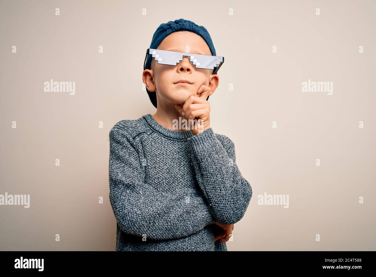 Young little caucasian kid wearing internet meme thug life glasses over ...