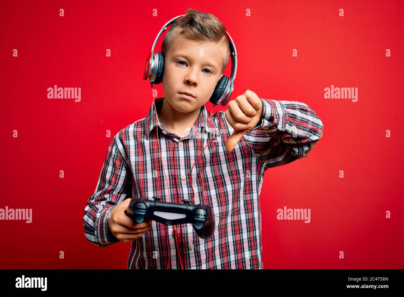 Young little caucasian gamer kid playing video games using gamepad ...